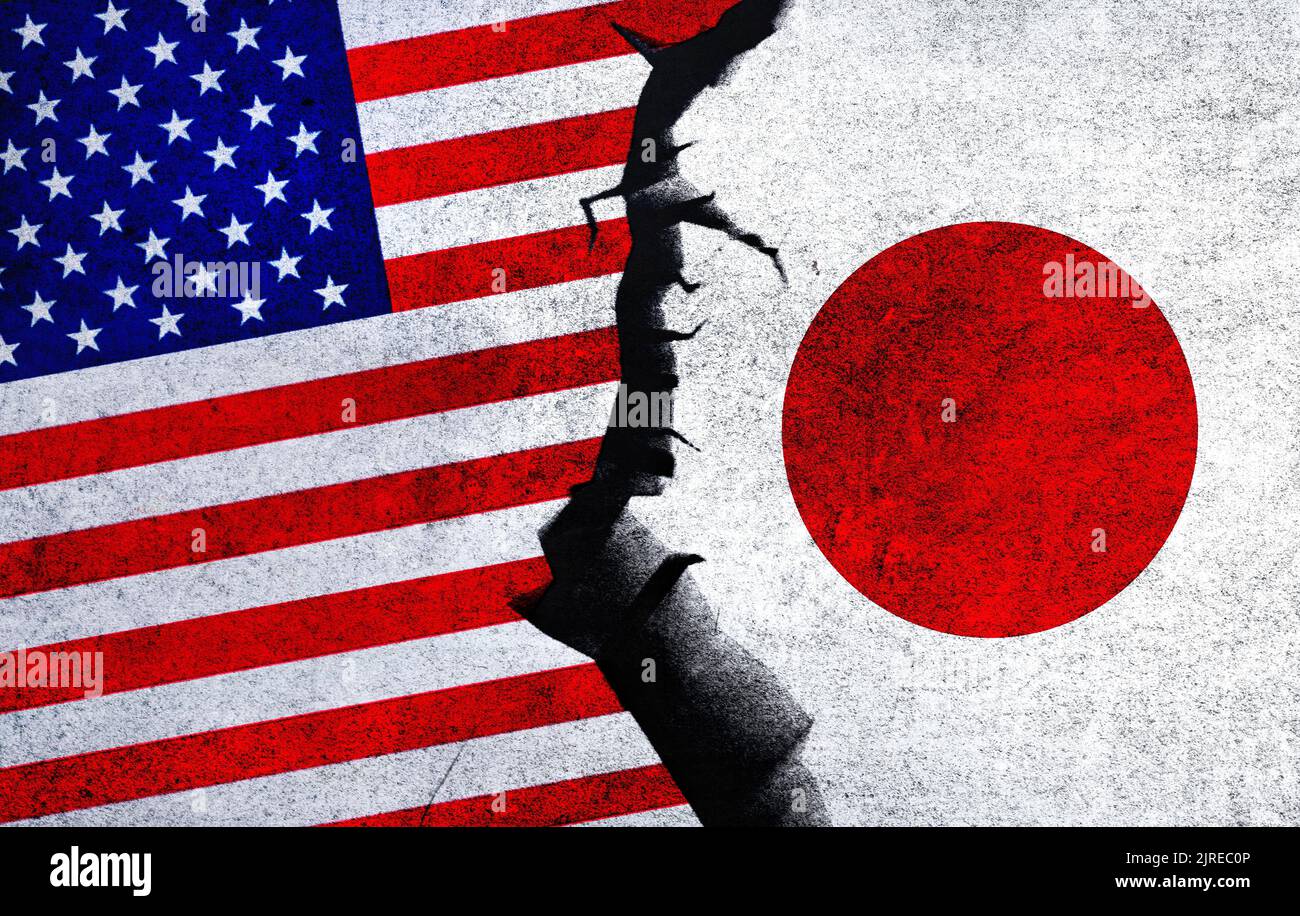 USA vs Japan flags on a wall with a crack. United States of America and ...