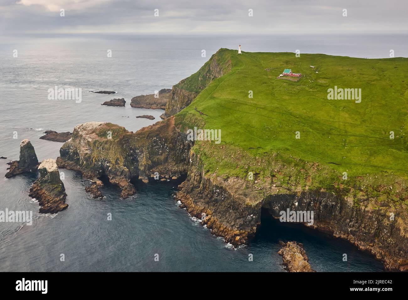 Mykines lighthouse and cliffs on Faroe islands from helicopter. Denmark ...