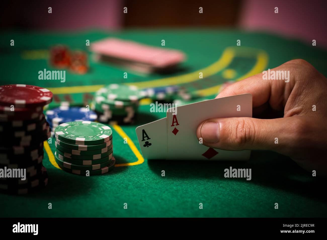 Happy poker player winning and holding cards Stock Photo - Alamy