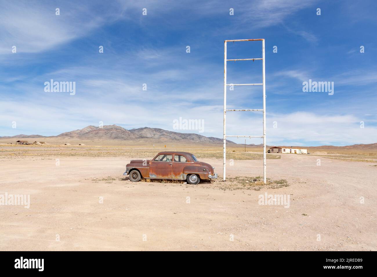 old rotten vintage car at a patrol station in the desert at Route 895 ...