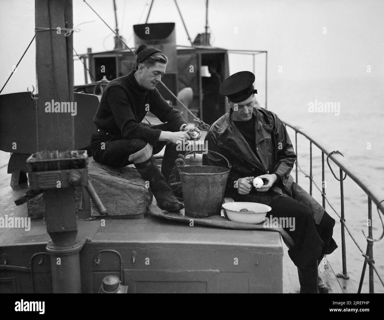 Sailors peeling potatoes aboard a Royal Navy trawler, 1942. Able Seaman ...