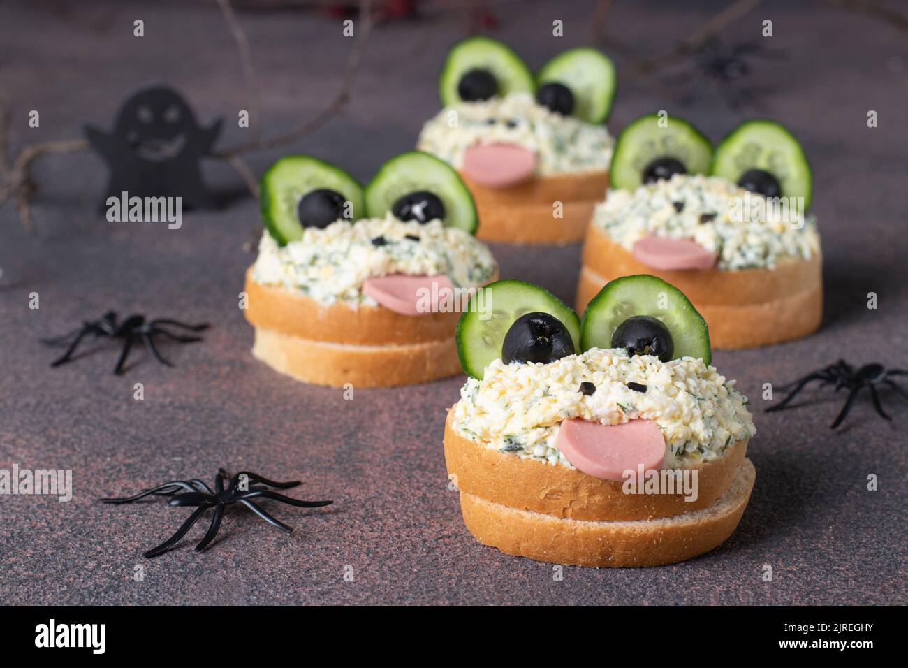 Cucumber, sausage, black olives, egg and melted cheese sandwiches in ...