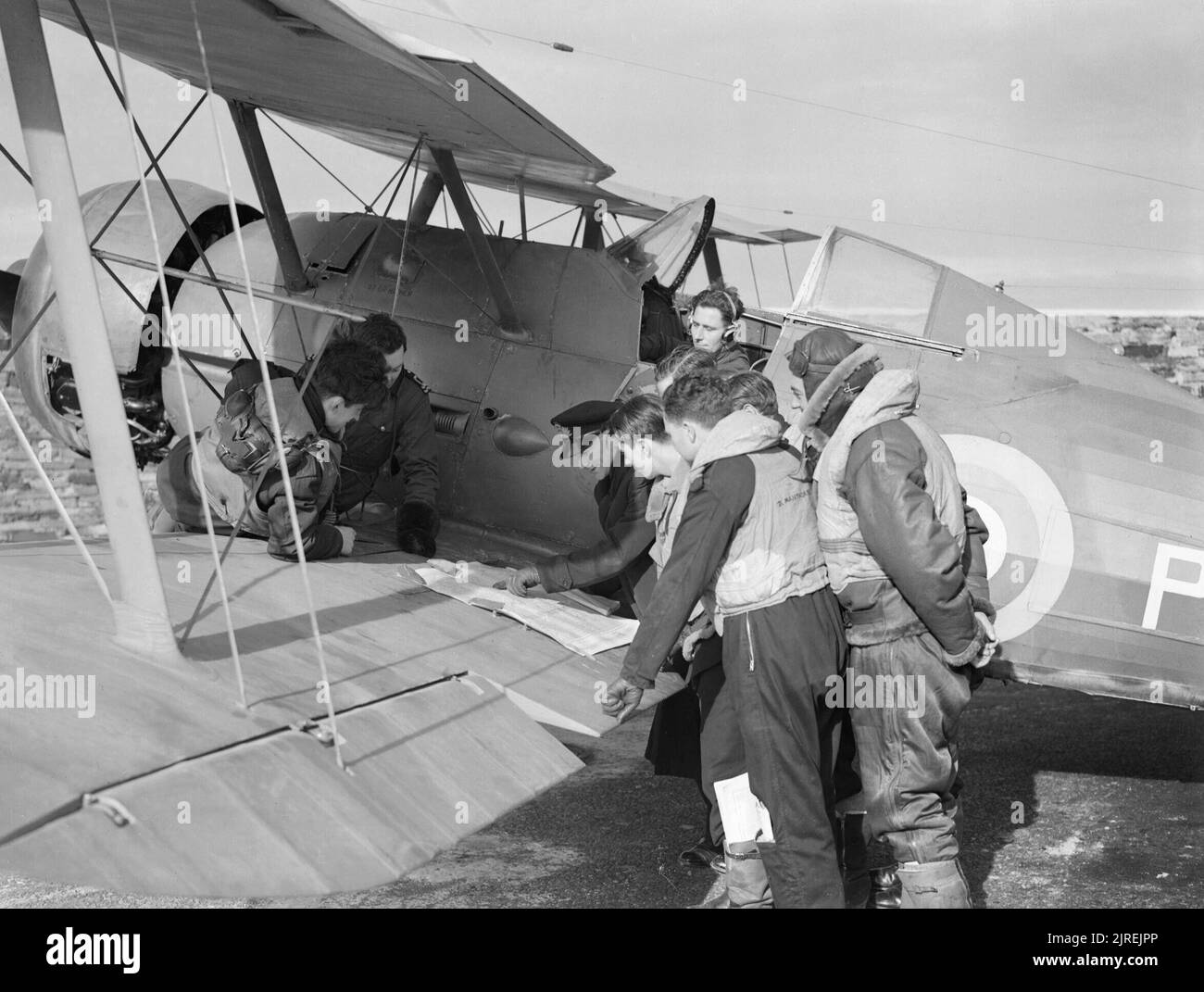 Fleet Air Arm pilots and a Gloster Gladiator at HMS SPARROWHAWK, the ...