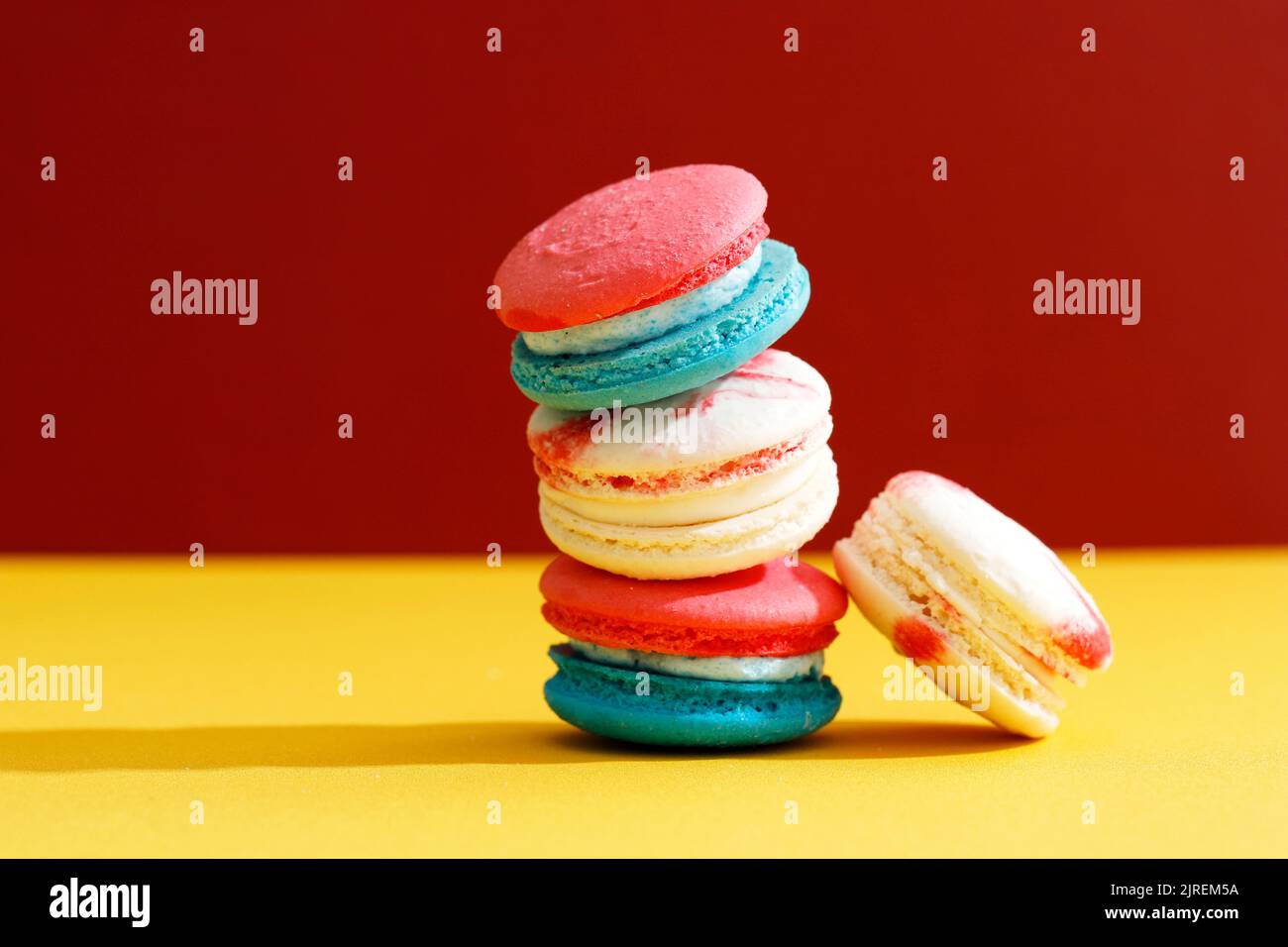 Stacked Macaroon on Red Background, Copy Space for Text Stock Photo - Alamy