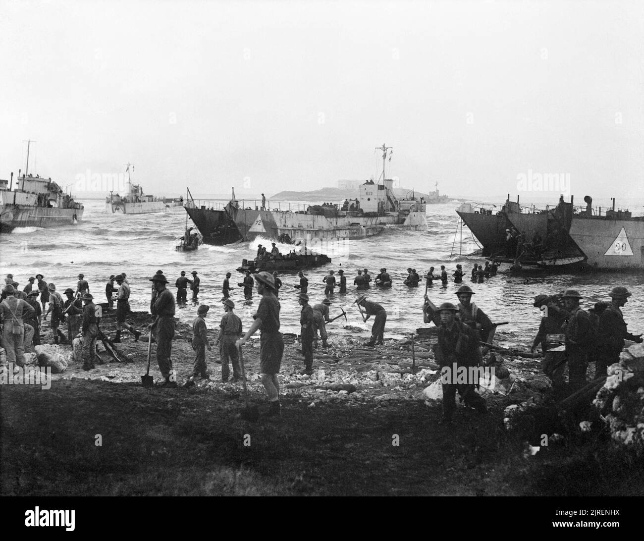 Troops from 51st Highland Division unloading stores from tank landing ...