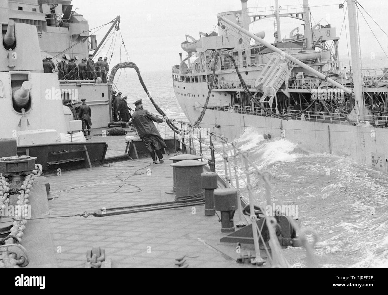 HMS JAMAICA refuelling at sea from a tanker, September 1944. Looking ...