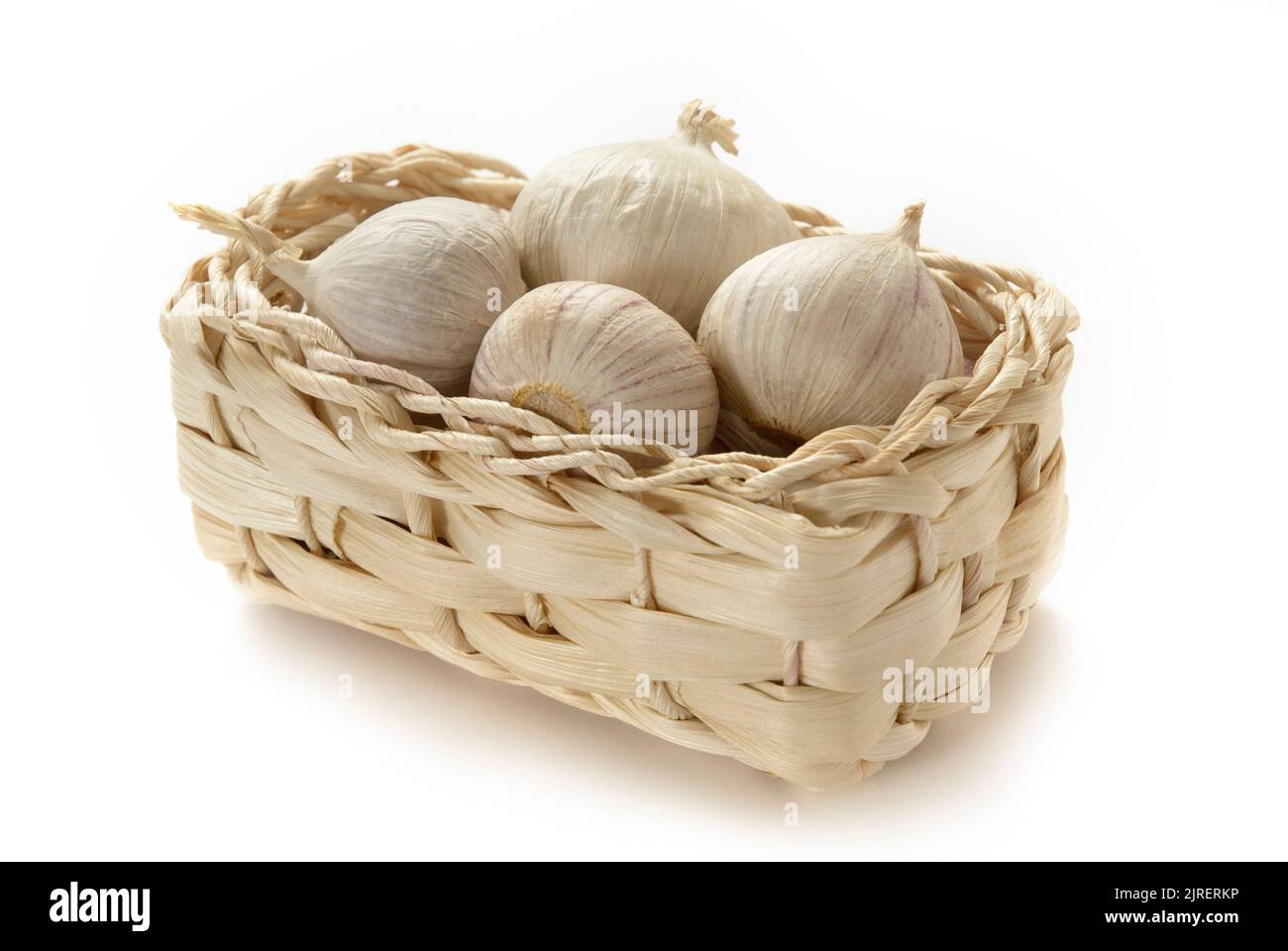 A small basket of garlic cloves on white background cut out Stock Photo ...