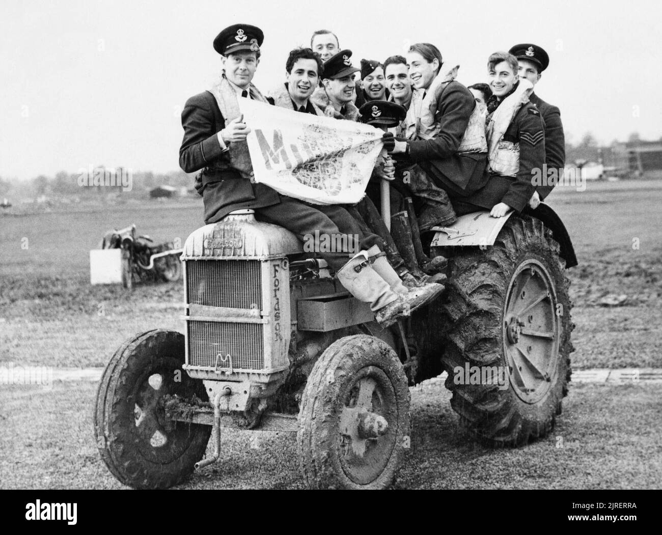 Pilots of No. 601 Squadron RAF use a tractor to negotiate muddy ...