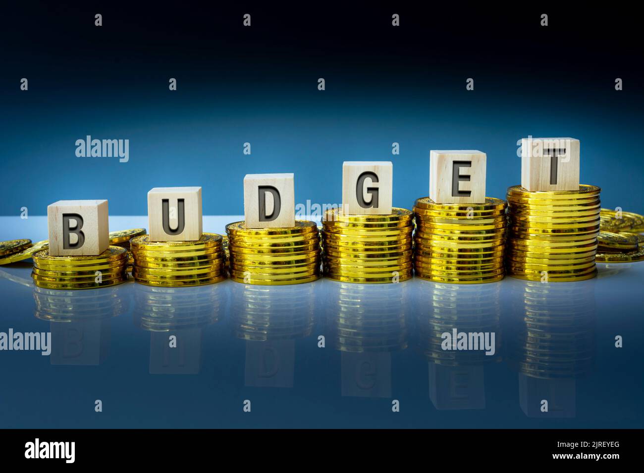 Budget text on wooden block with a pile of gold coins. Business concept ...