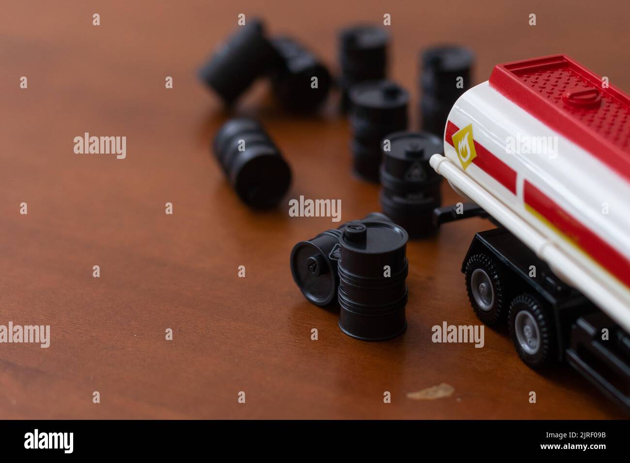 small toy combine with toy oil barrel Stock Photo - Alamy