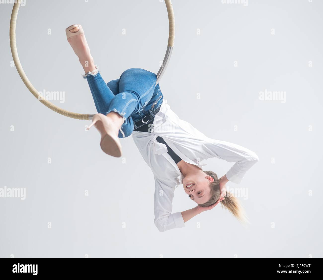 Caucasian woman in casual clothes on an aerial hoop Stock Photo - Alamy