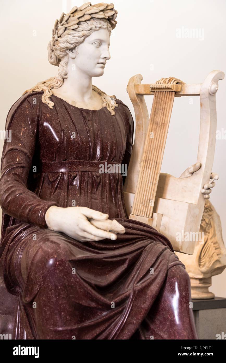 Ancient marble statue of woman wearing a crown of laurels playing the ...