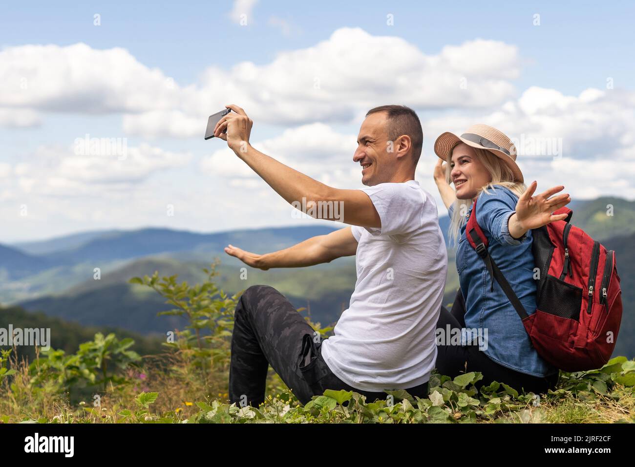 Portrait of beautiful young couple enjoying nature at mountain peak Stock Photo - Alamy