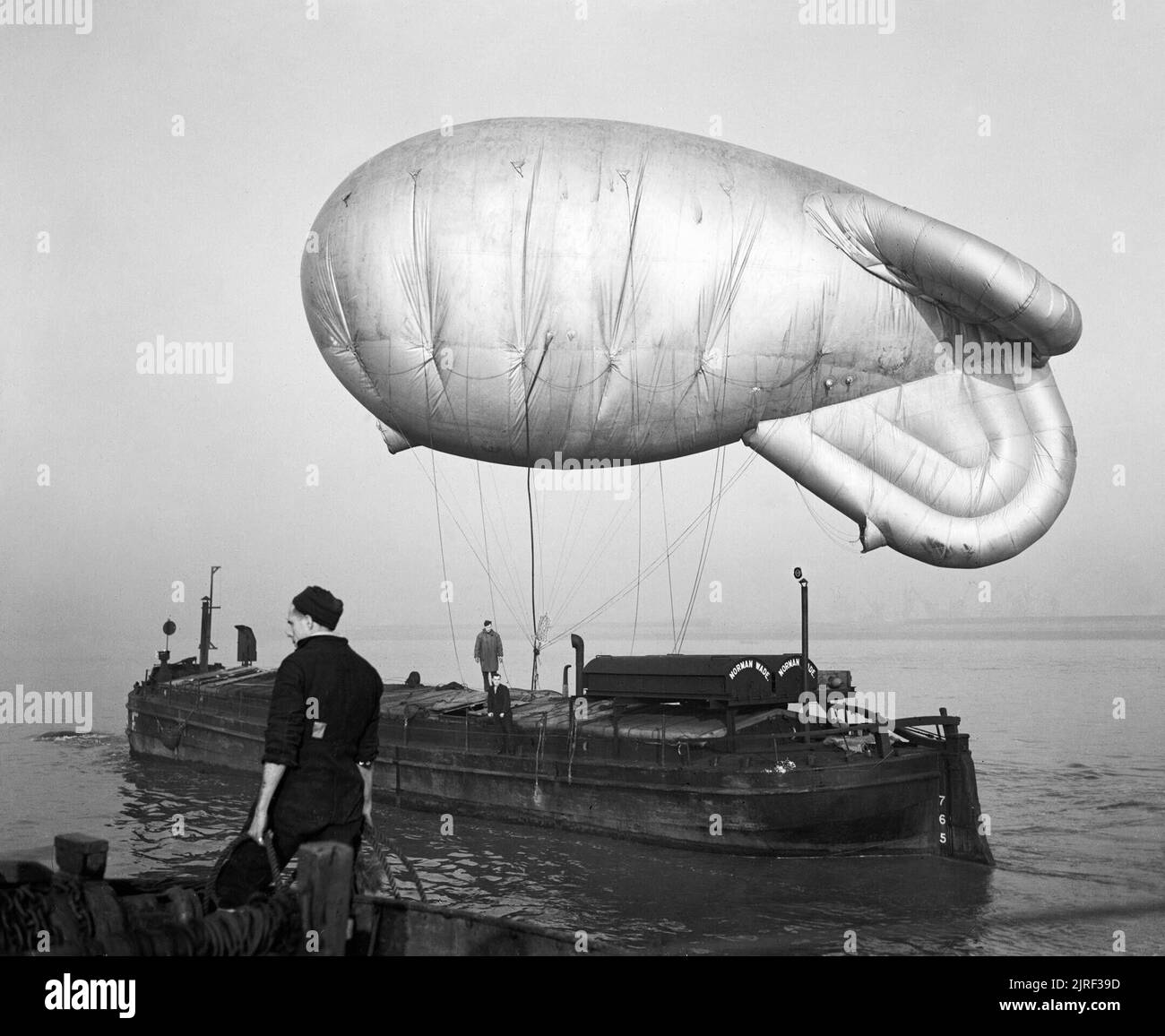 A kite balloon tethered to the balloon barge NORMAN WADE on the River ...