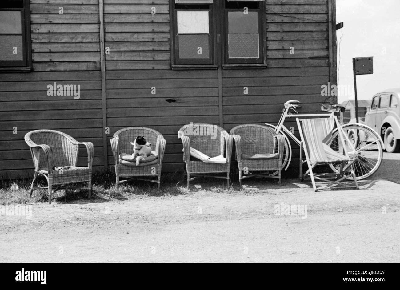 Empty chairs and parked bicycles leaning against a dispersal hut at ...