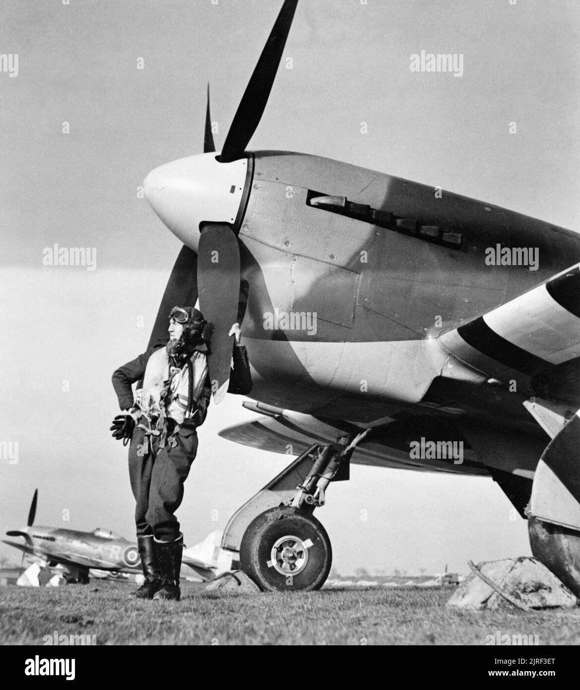 Flying Officer J R Cullen of No. 486 Squadron RNZAF, standing in front ...