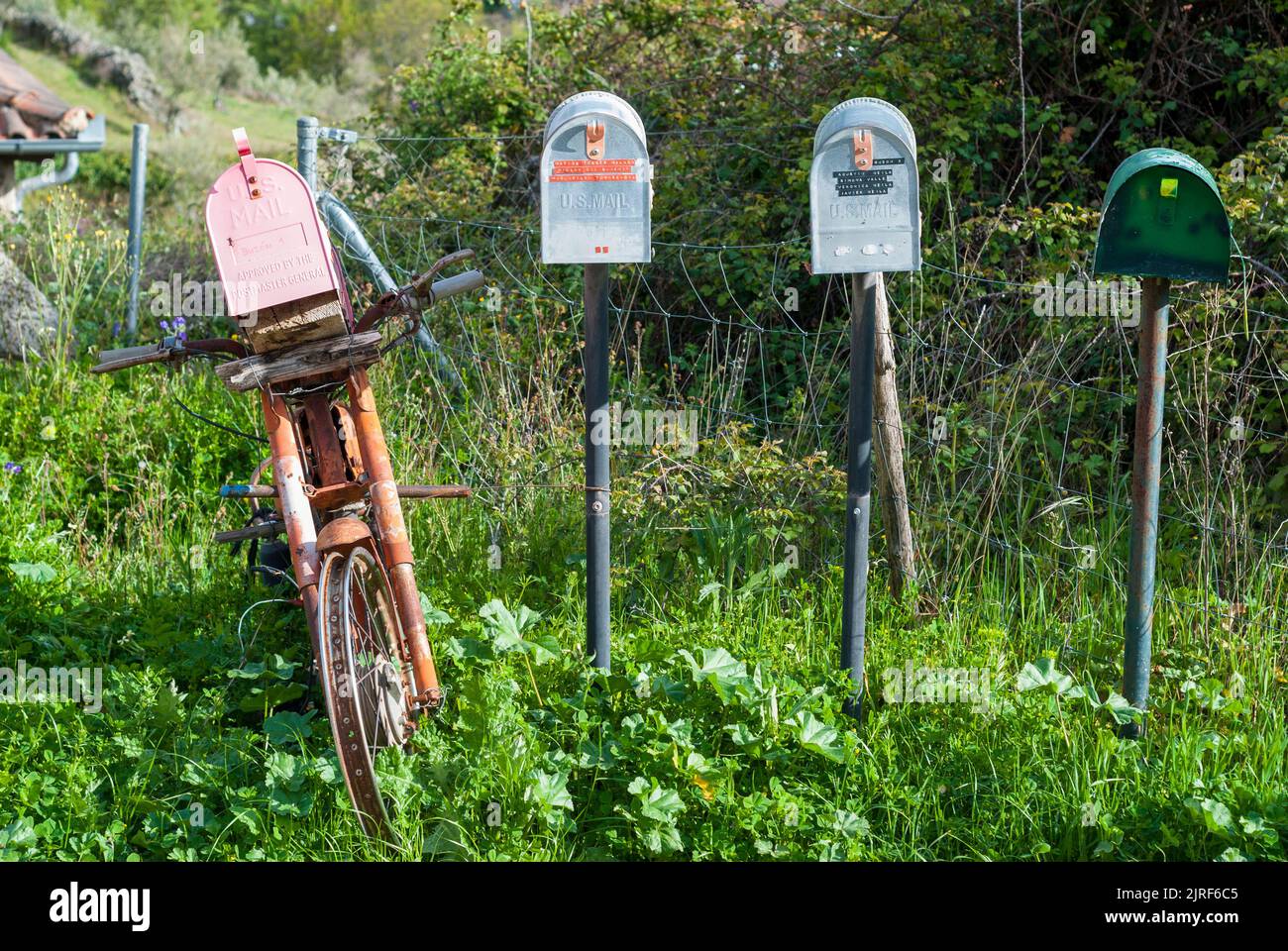 recycled retro mailboxes with old rusty vintage motorcycle in the ...