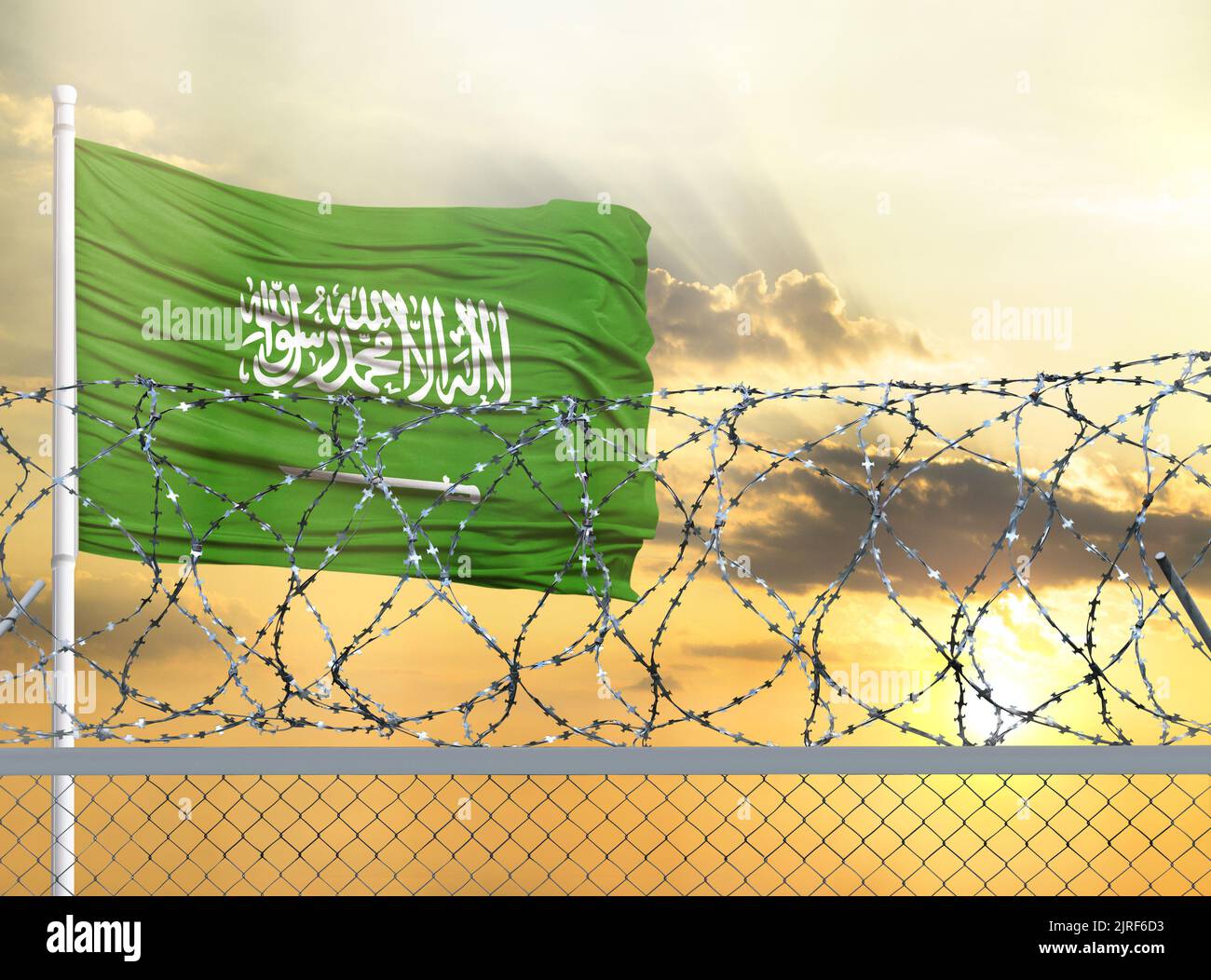 Flagpole with the flag of Saudi Arabia against the sky and behind a ...