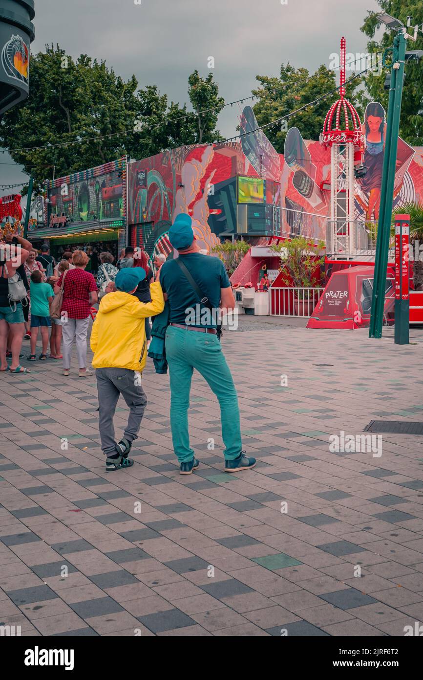 Father and son look up at the sky and see the Prater rides in Vienna ...
