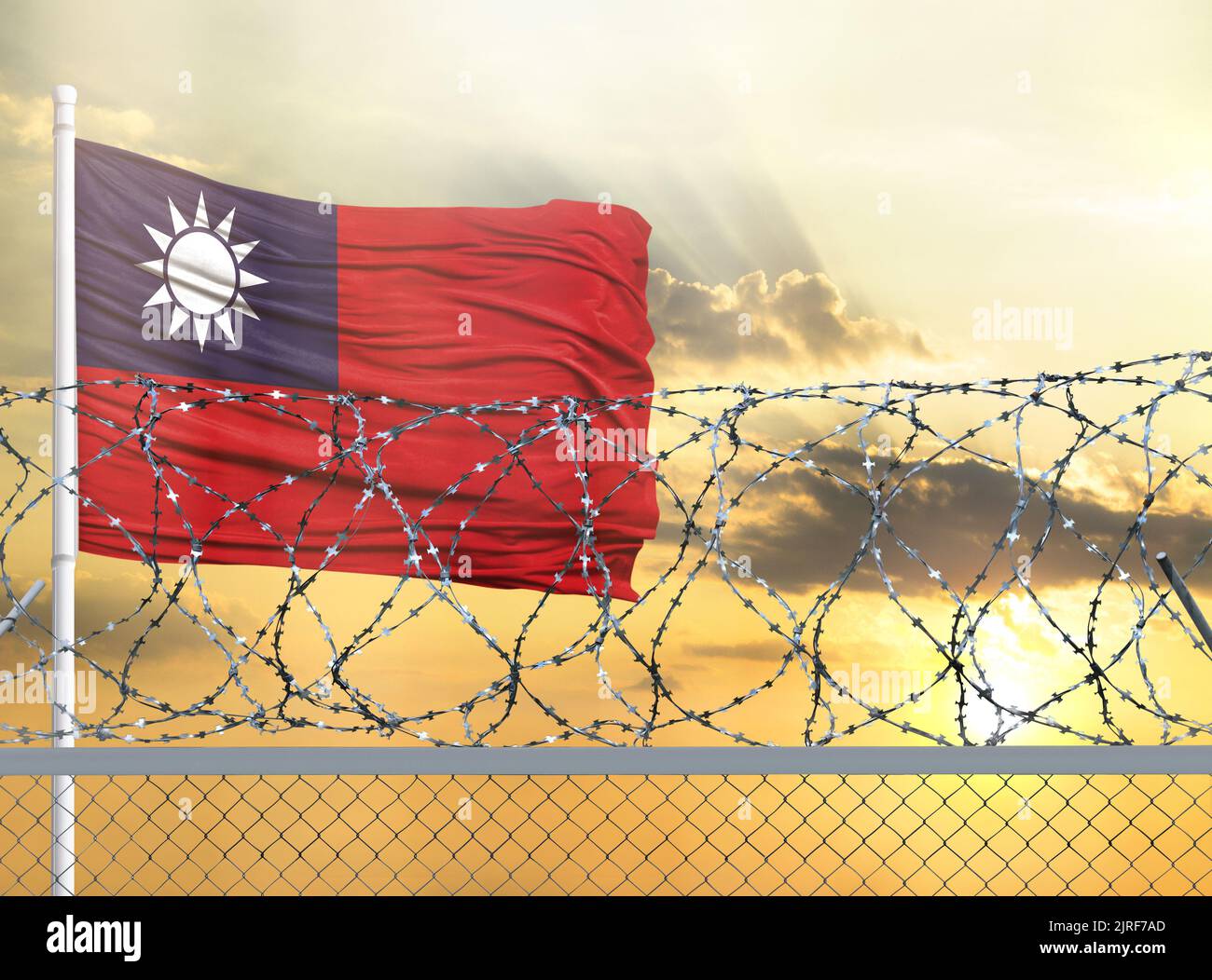 Flagpole with the flag of Taiwan against the sky and behind a fence ...