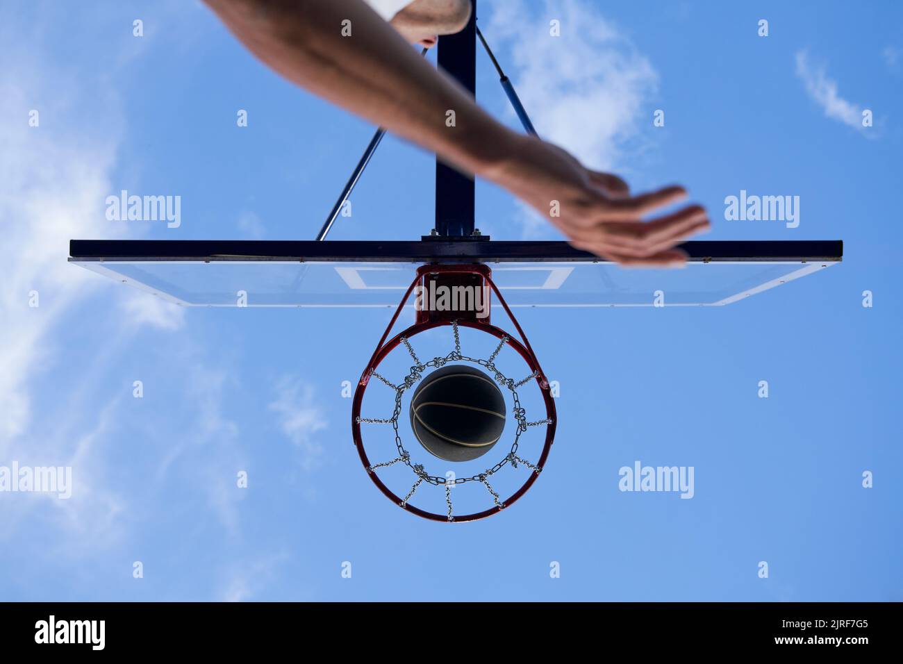Close-up of the ball being thrown into the hoop. Bottom view. Street ...