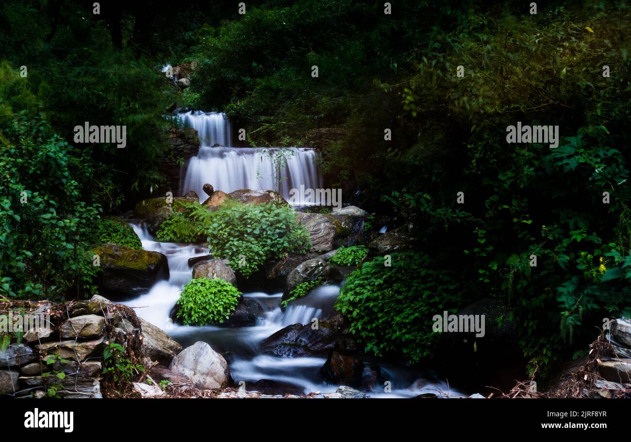Long exposure shot with silky water fall , river flowing through the ...