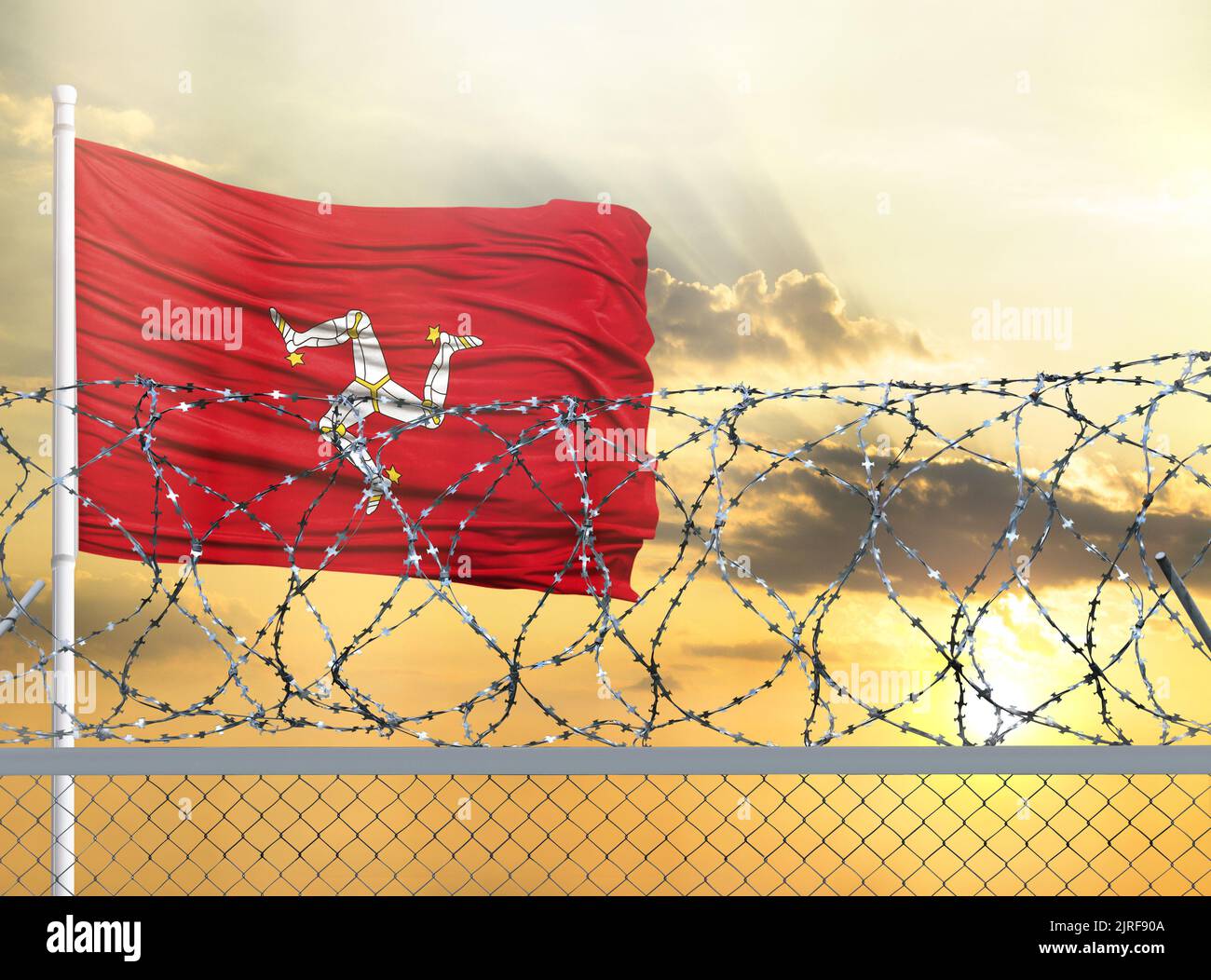 Flagpole with the flag of Isle Of Man against the sky and behind a ...