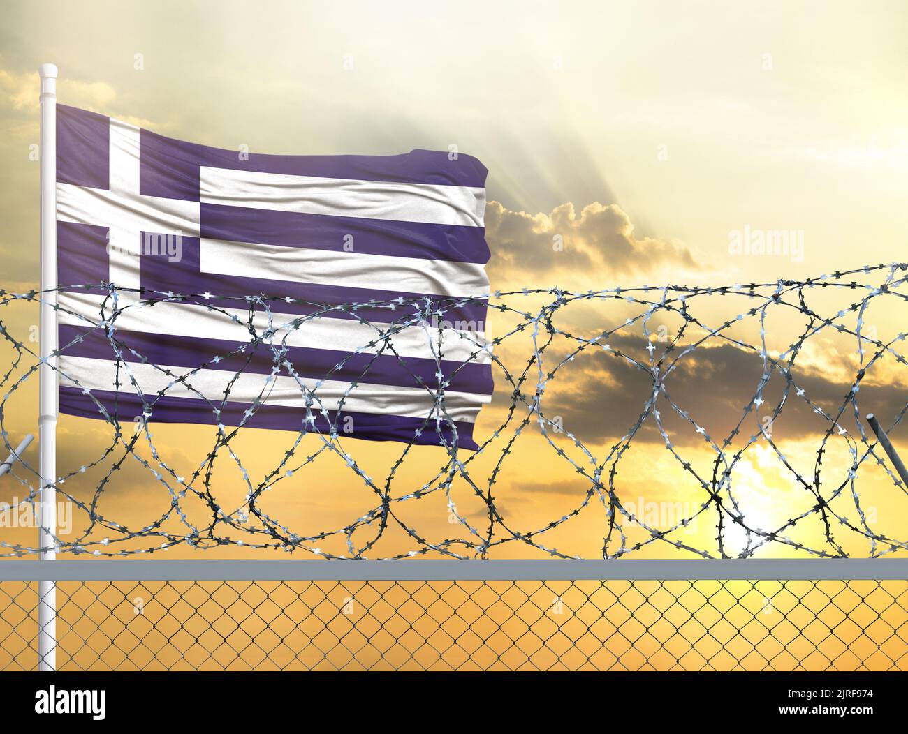 Flagpole with the flag of Greece against the sky and behind a fence ...