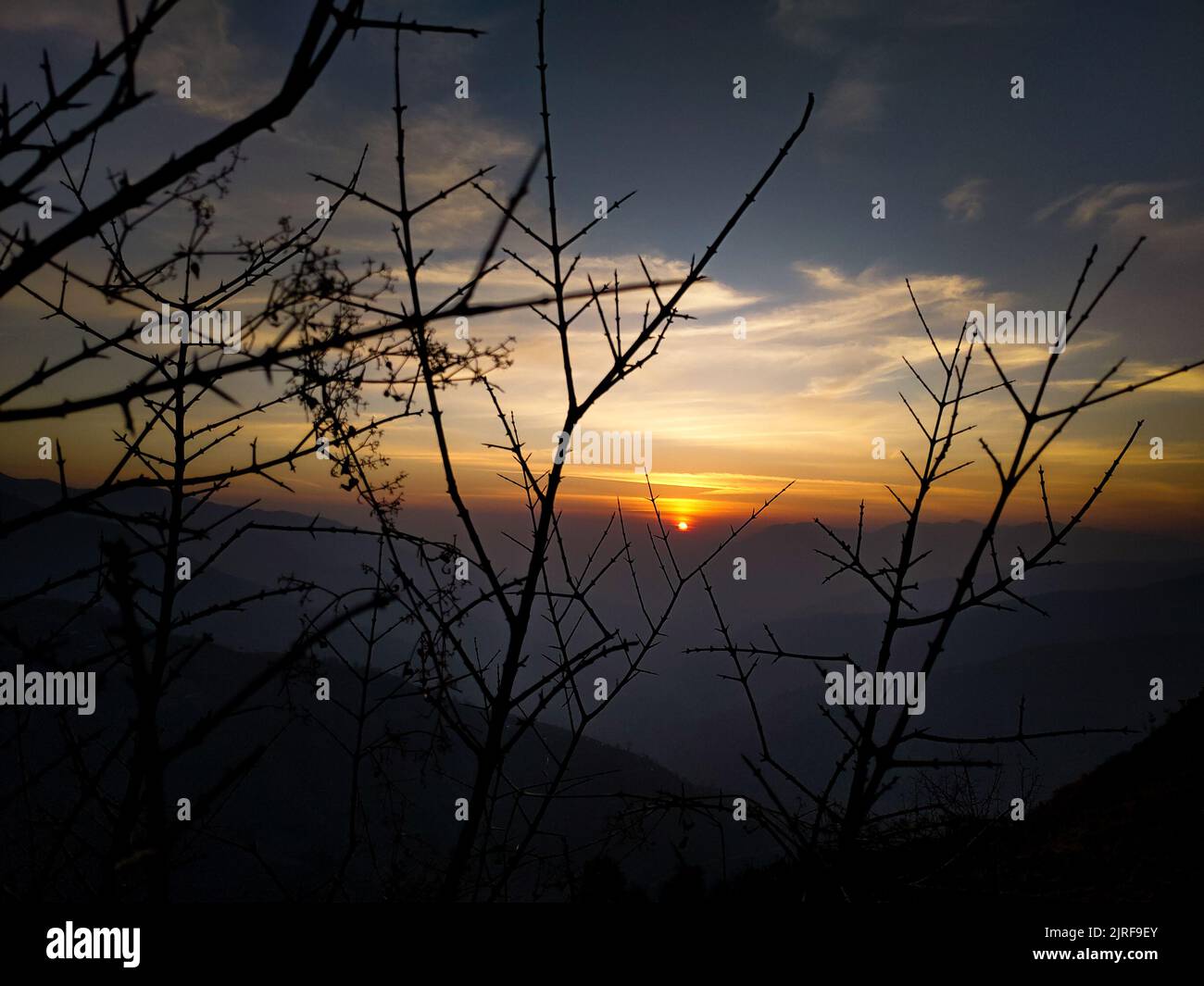 Dehradun, uttarakhand India. Small round Sun at the horizon just before ...
