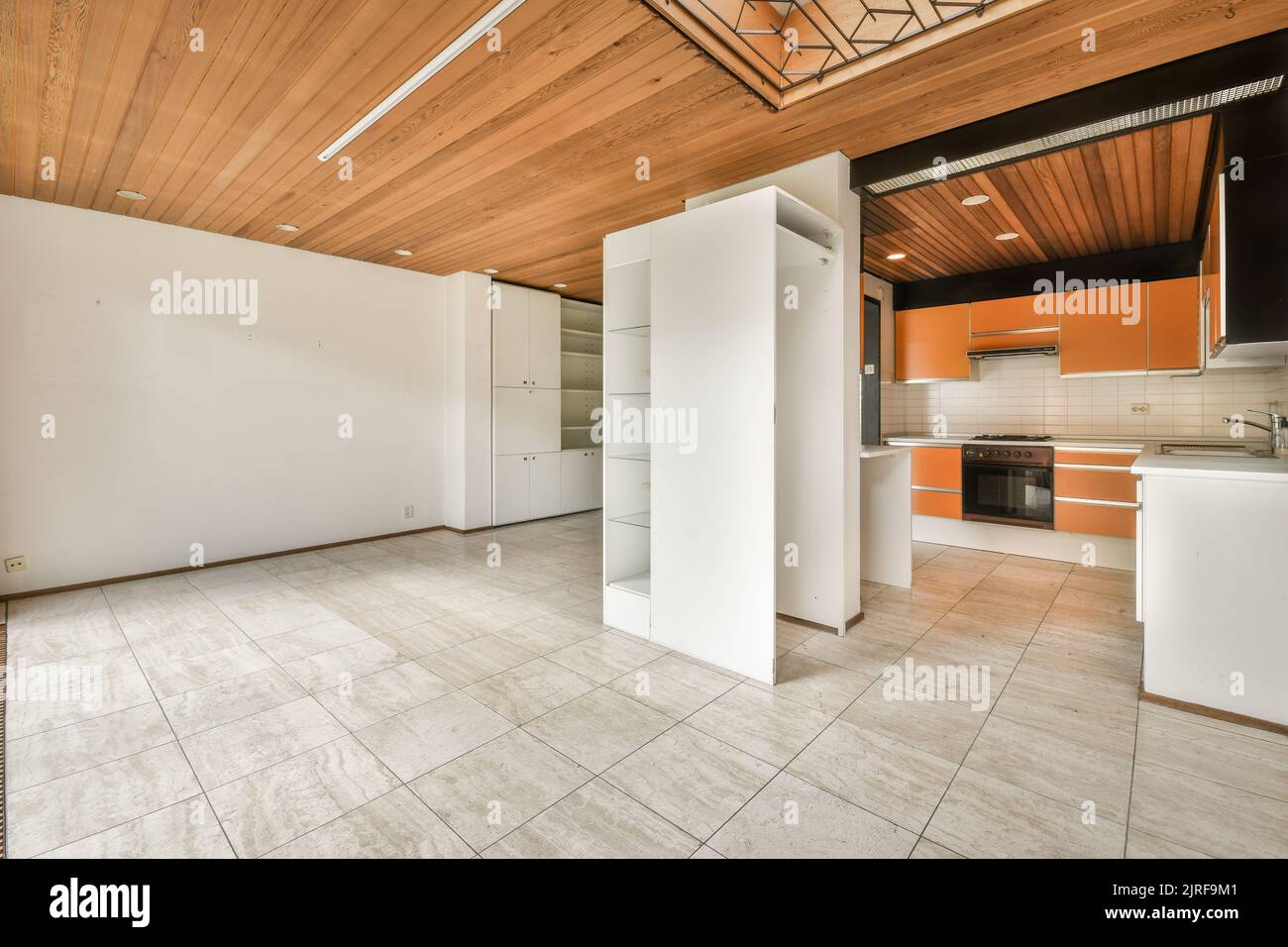 Interior of empty white kitchen with corridor and wooden parquet floor ...