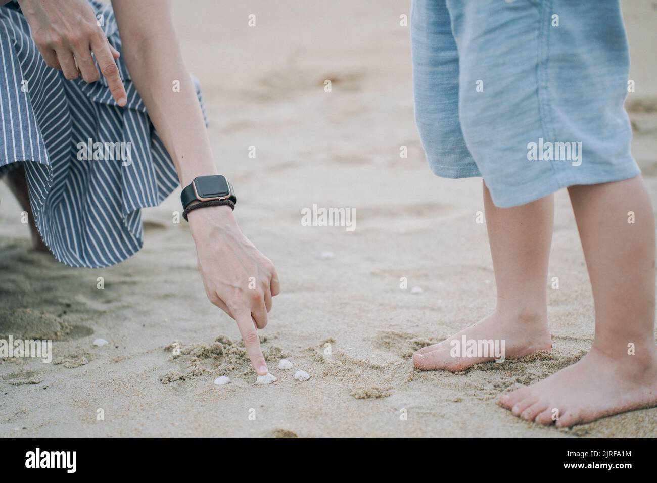 Boy touching legs hi-res stock photography and images - Alamy