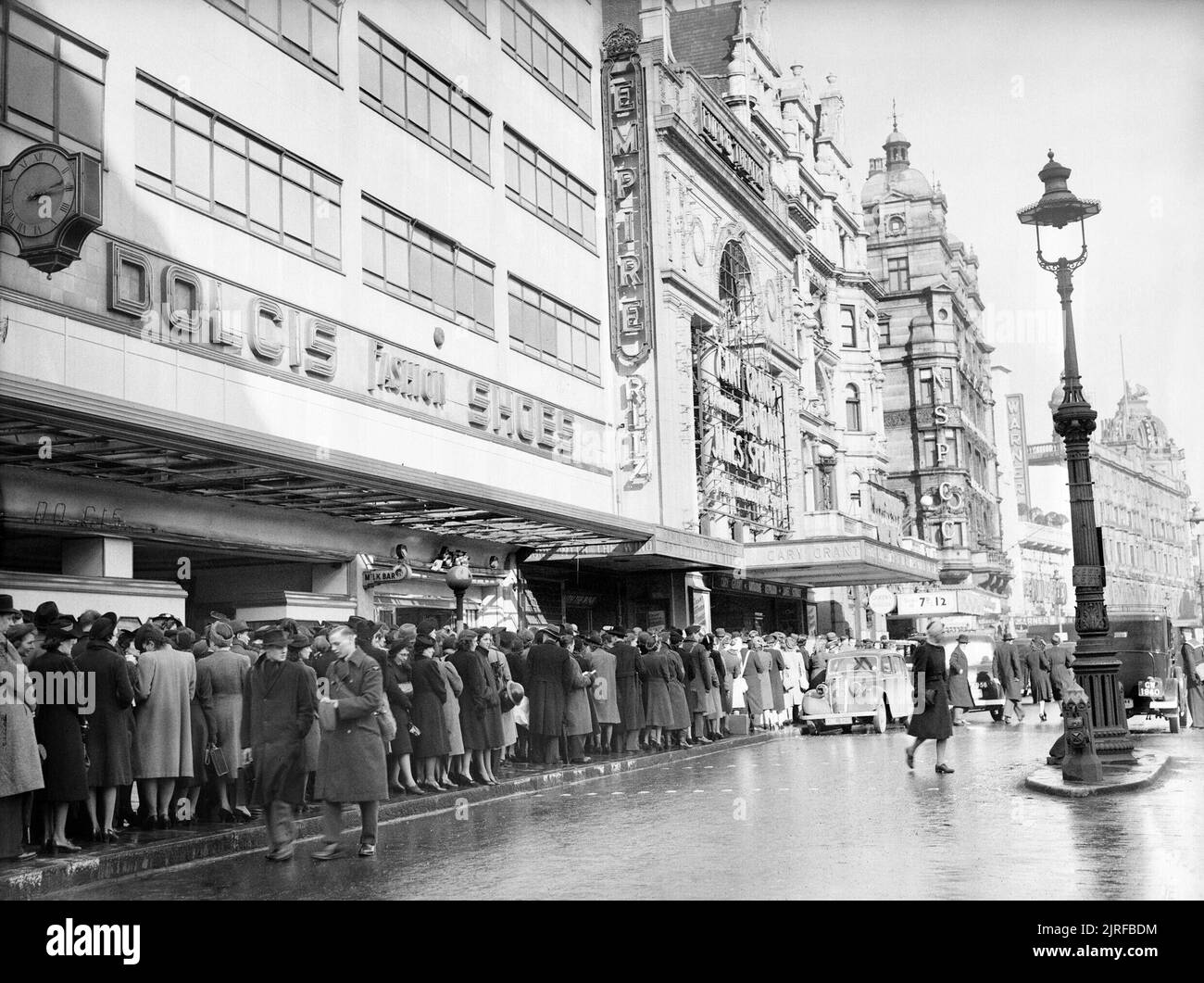 Service personnel and civilians queue for admission to the Empire and ...
