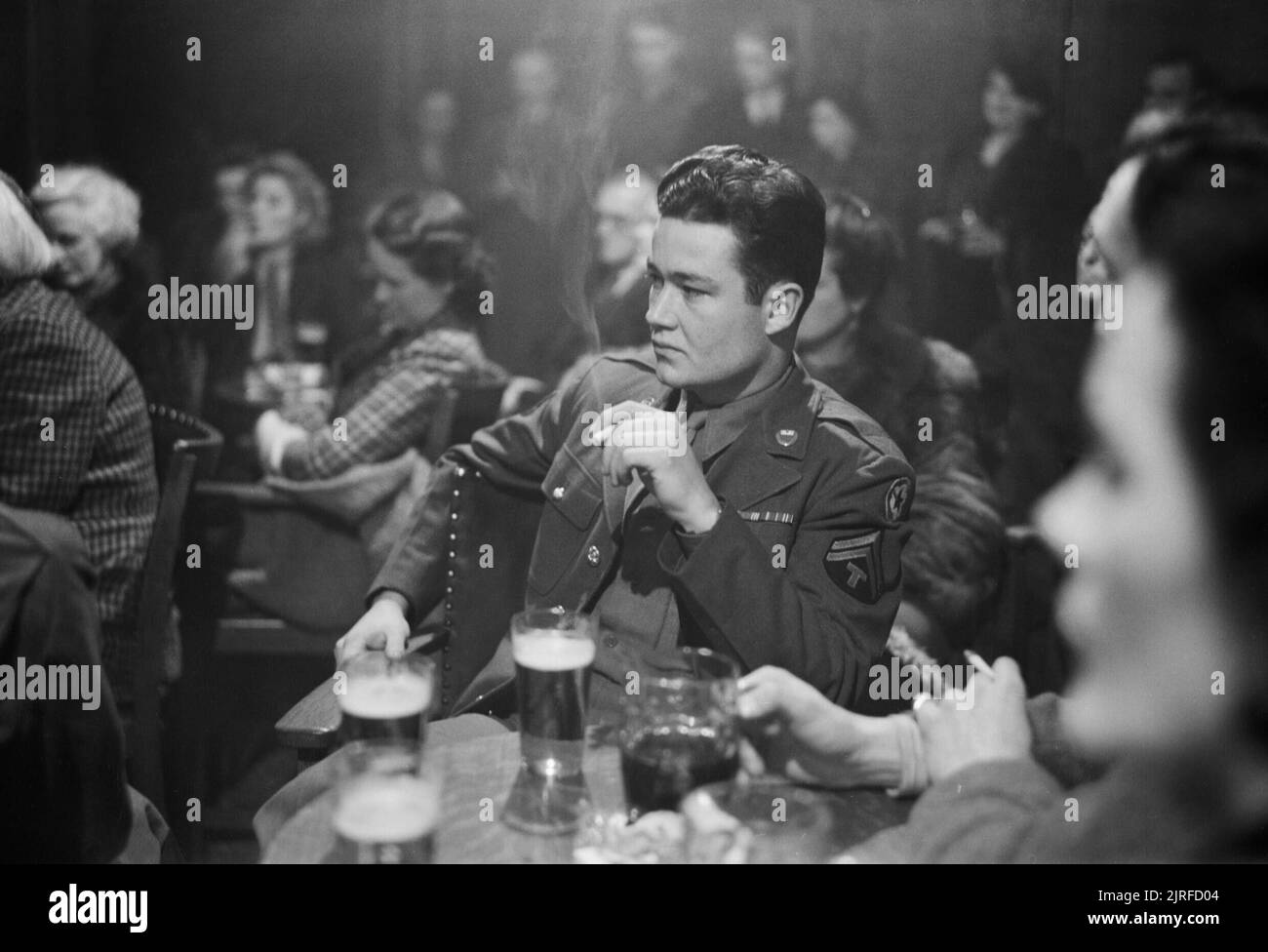 An American soldier listening to a speaker at a debating society ...