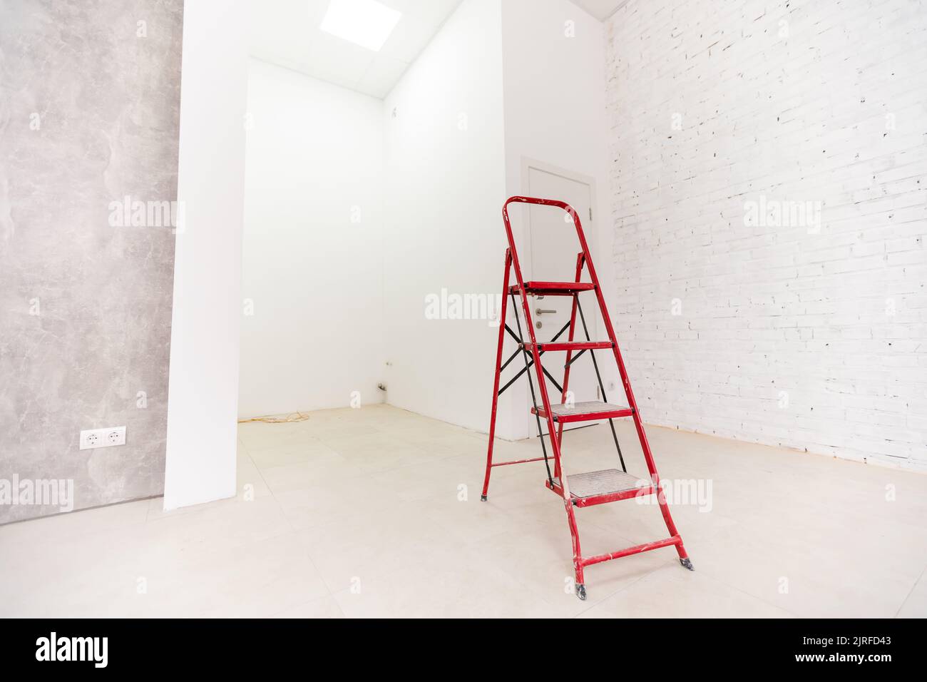 Painting walls in room with ladder during renovation Stock Photo - Alamy