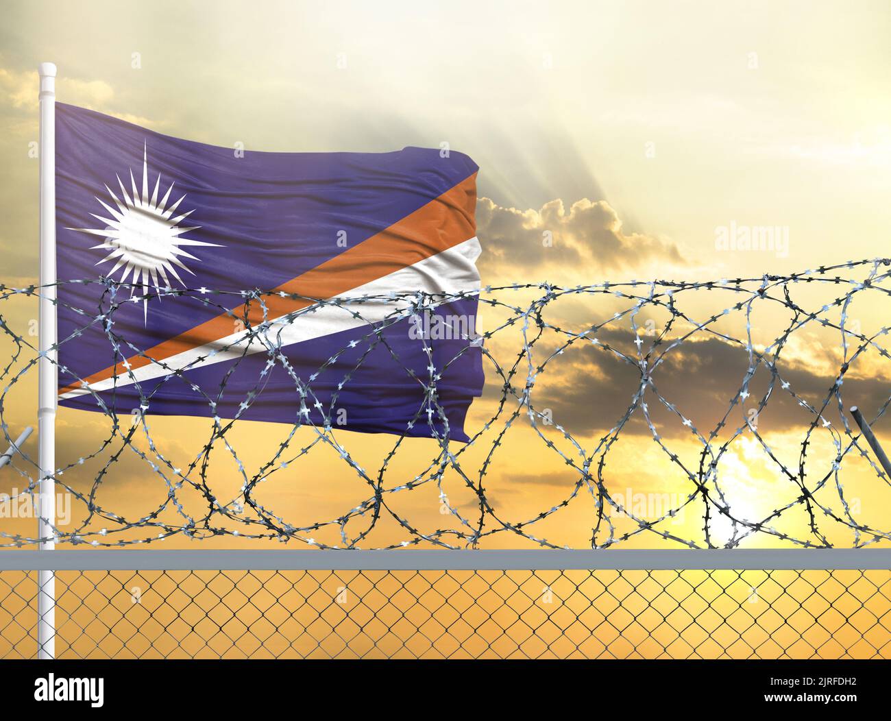 Flagpole with the flag of Marshall Islands against the sky and behind a ...