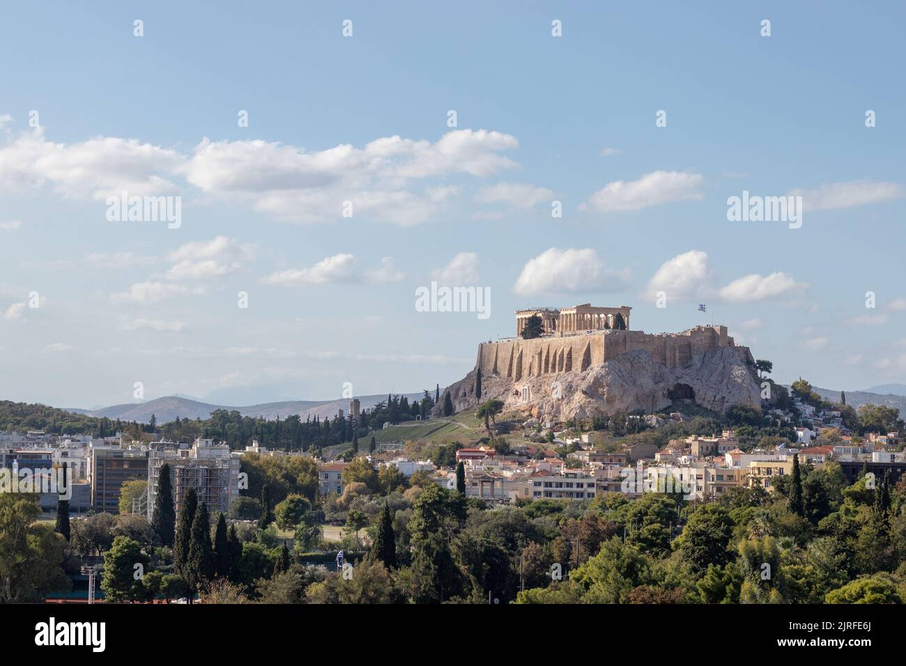 A shot of cityscape of Athens with Acropolis blue sky in the background ...
