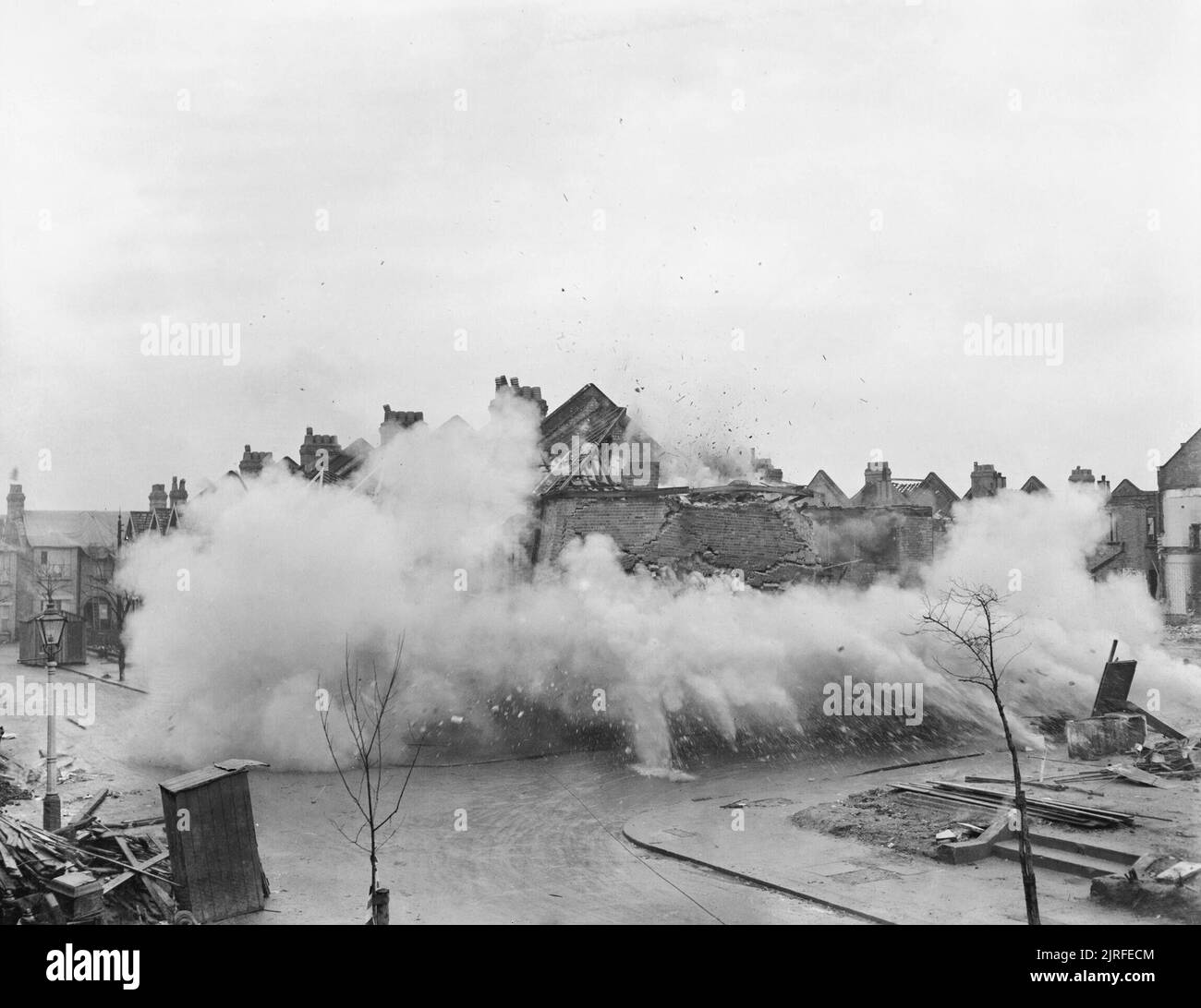 A bomb damaged house is brought down with high explosives to reproduce ...