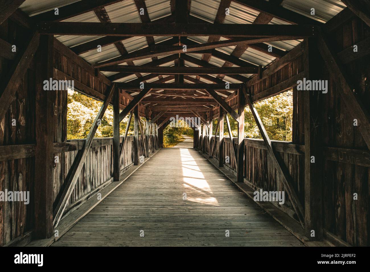 An inside view of a covered wooden bridge with sunlight Stock Photo - Alamy
