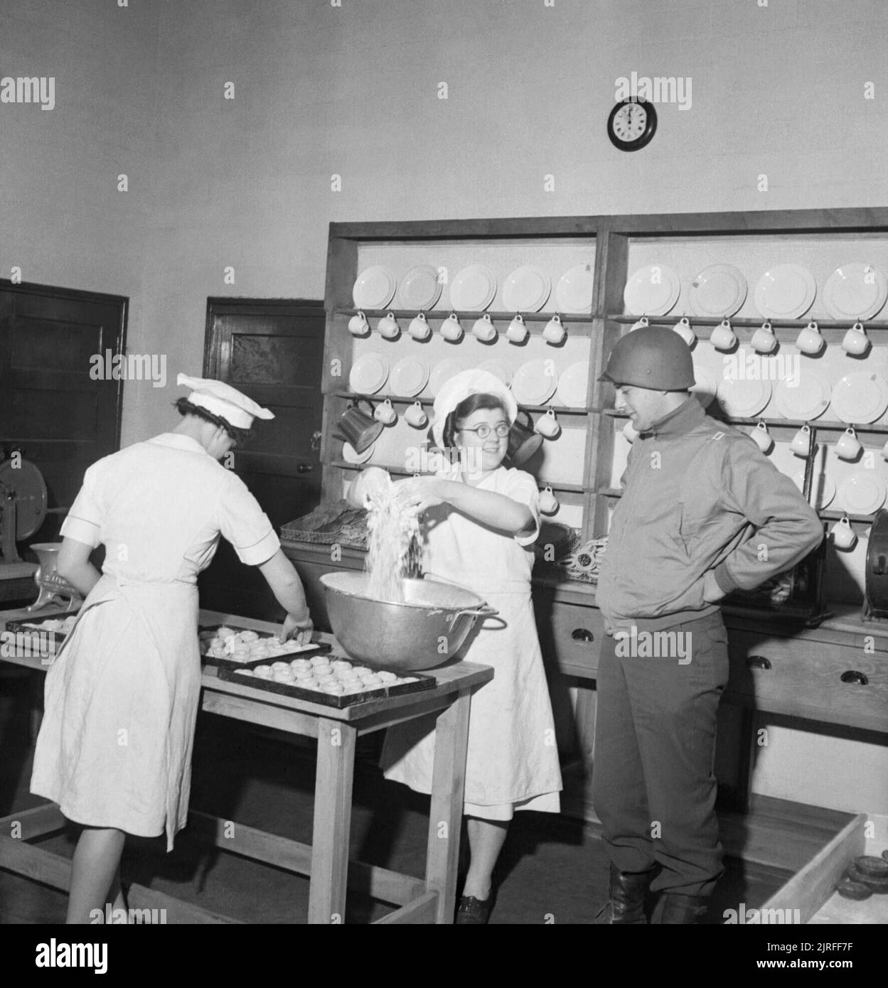 Captain Robert Russell of the US Army inspecting work in the kitchen of ...