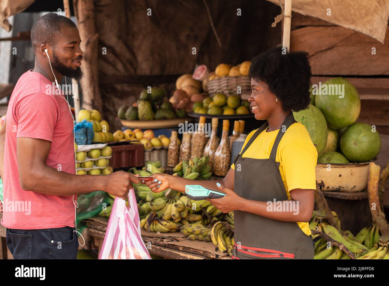 african woman selling in a market collecting credit card Stock Photo ...