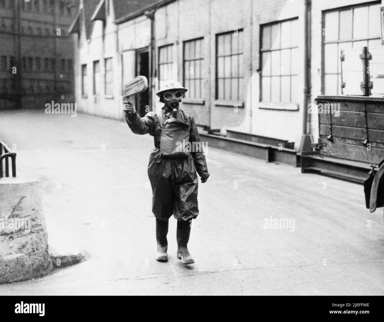 An air-raid warden sounds a gas alert with his rattle during an ...