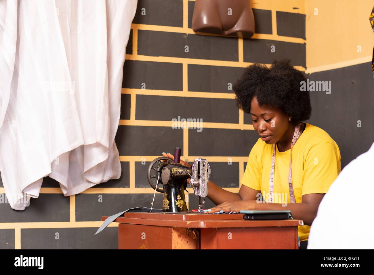 female african tailor sewing with her machine Stock Photo - Alamy