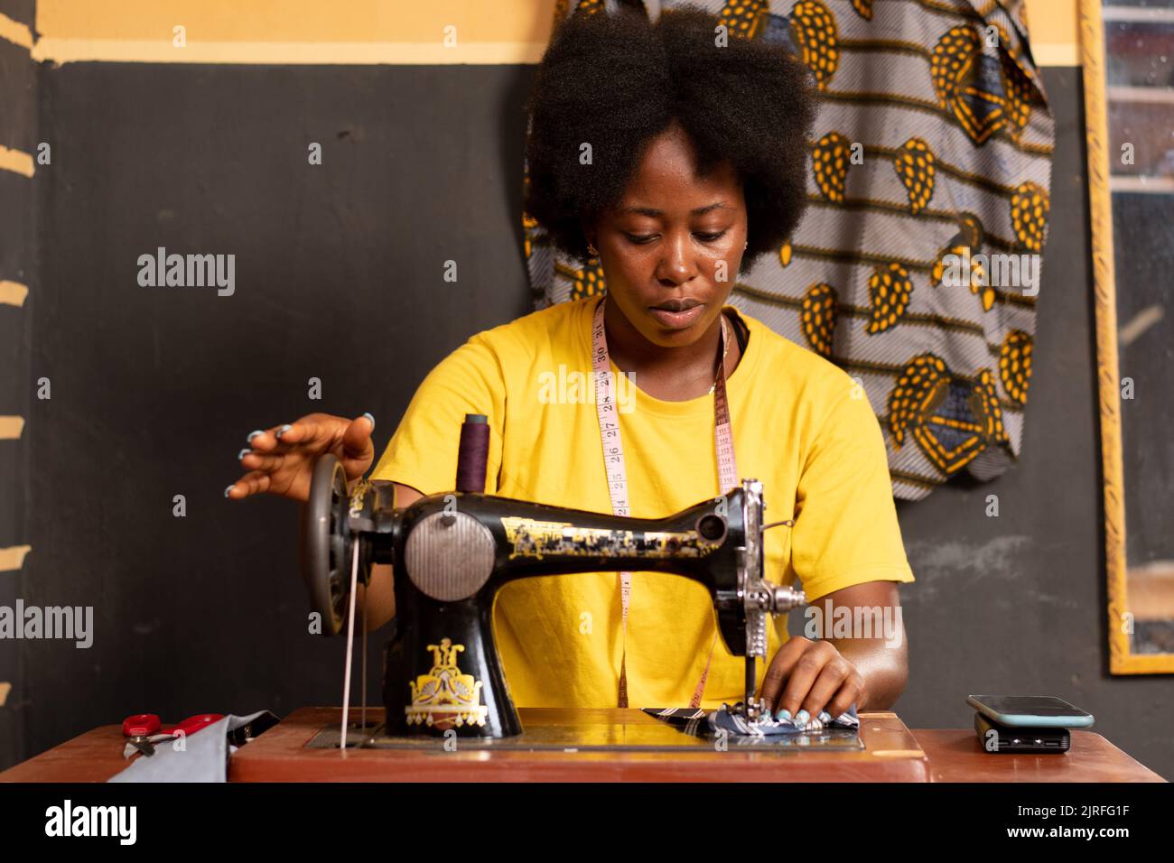 female african tailor sewing with her machine Stock Photo - Alamy