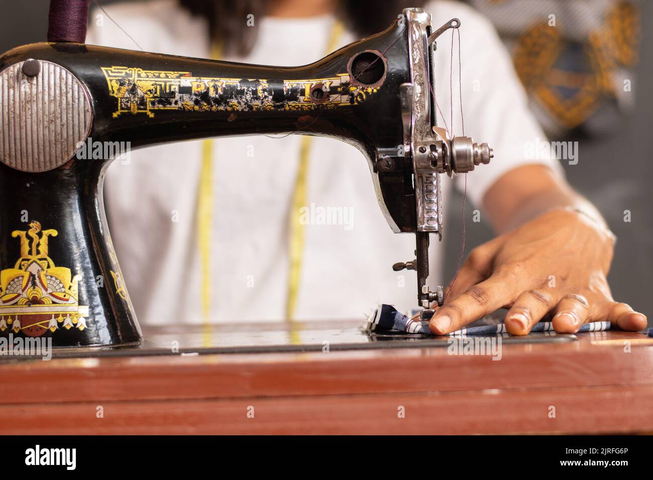 african tailor working in her shop with a sewing machine Stock Photo ...