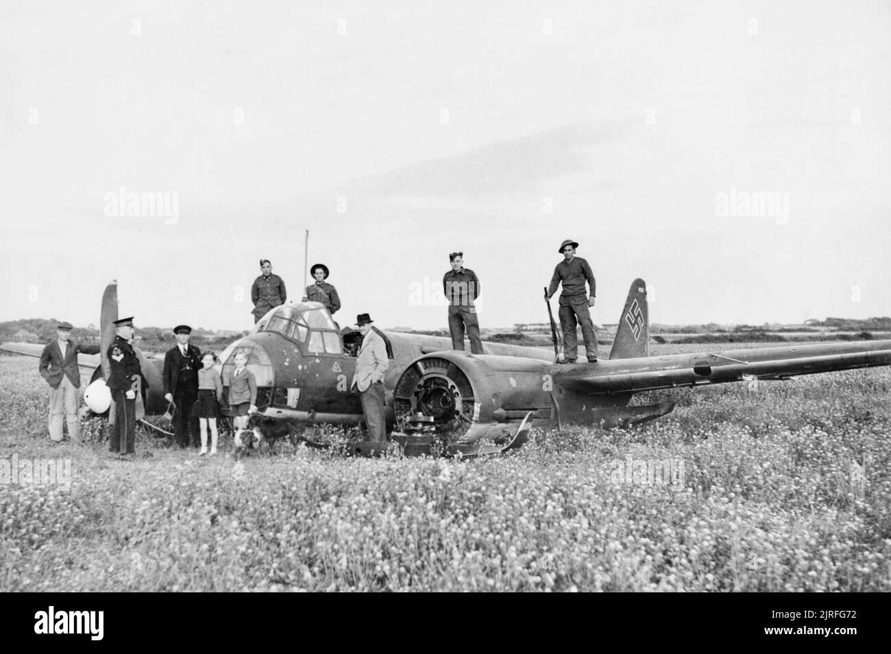 The Battle of Britain Troops and civilians pose with Junkers Ju 88A-1 (B3+BM) of 4./KG 54, which ...