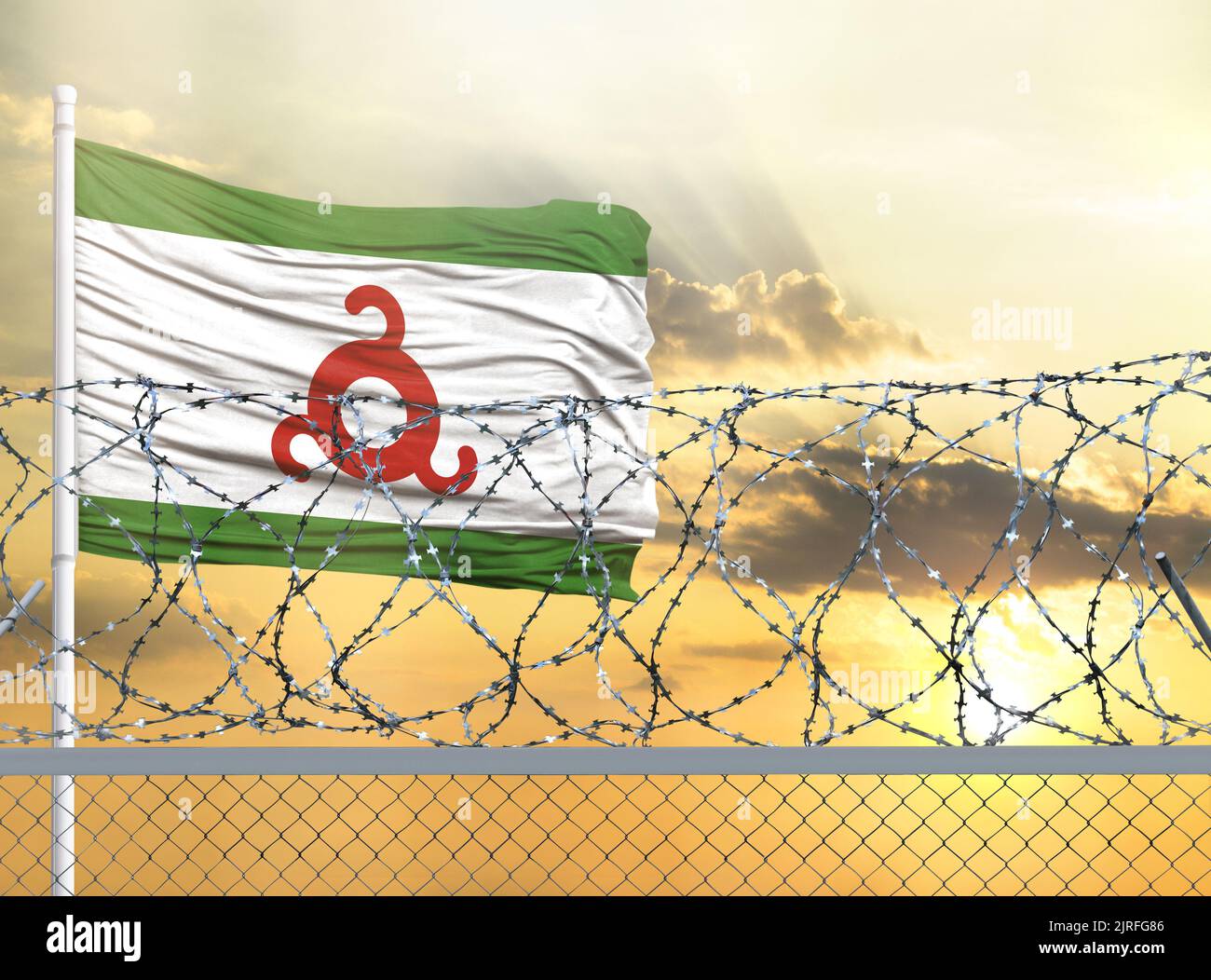 Flagpole with the flag of Ingushetia against the sky and behind a fence ...