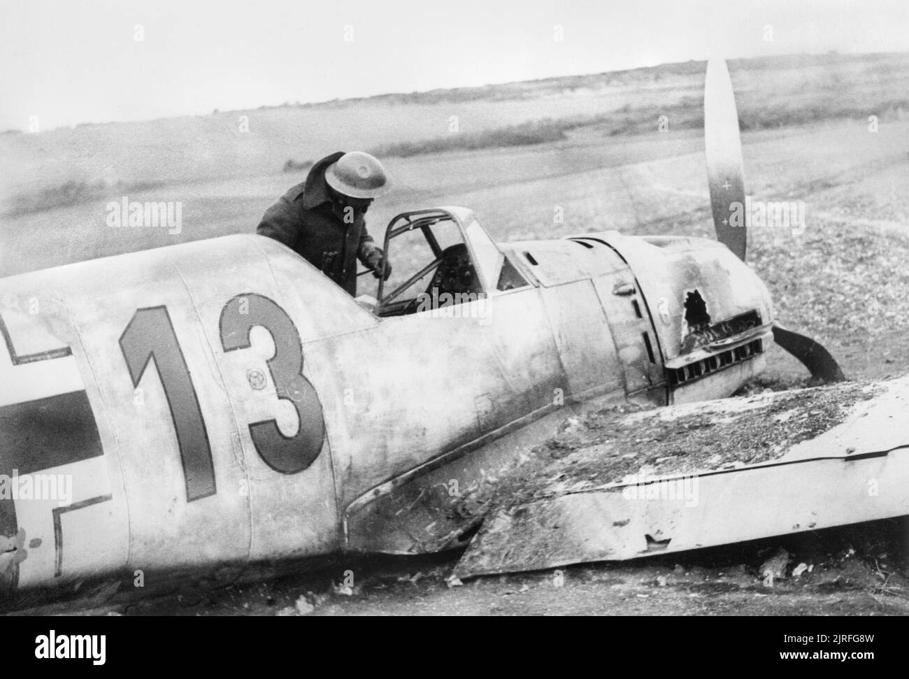 The Battle of Britain A soldier peers into the cockpit of a downed Messerschmitt Bf 109E. This ...