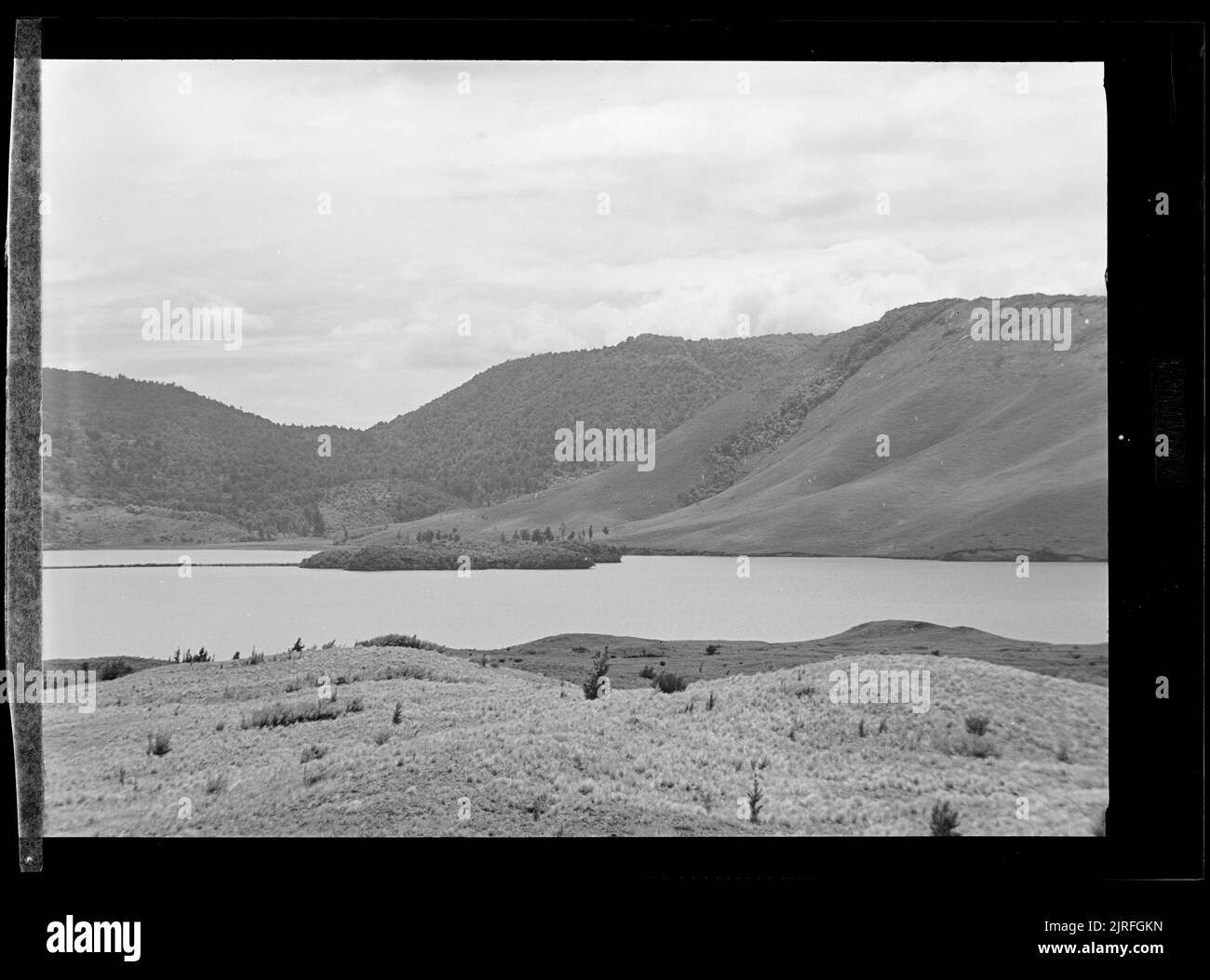 View of hills and the water, by J.W. Chapman-Taylor Stock Photo - Alamy