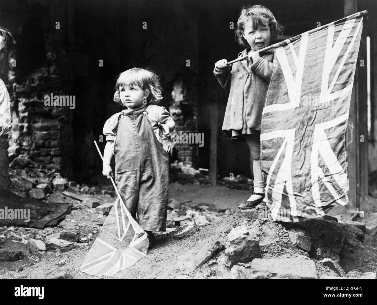Ve Day in London, 8 May 1945 Two small girls waving their flags in the ...