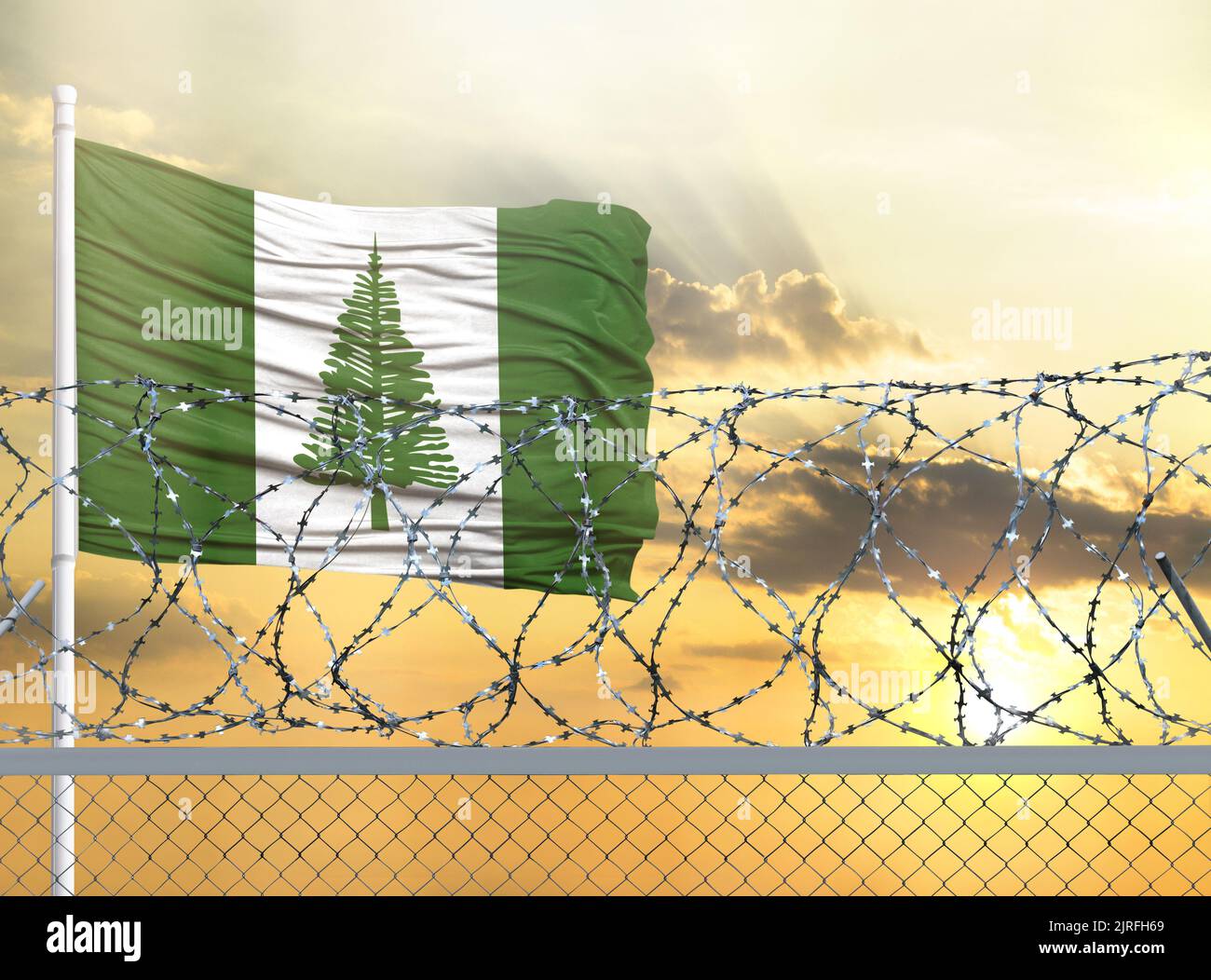 Flagpole with the flag of Norfolk Island against the sky and behind a ...